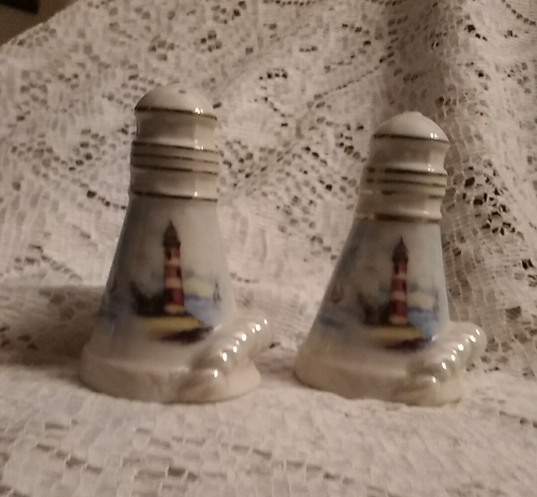 A Pair of Ivory Porcelain Lighthouse Shaped Salt and Pepper Shakers ...