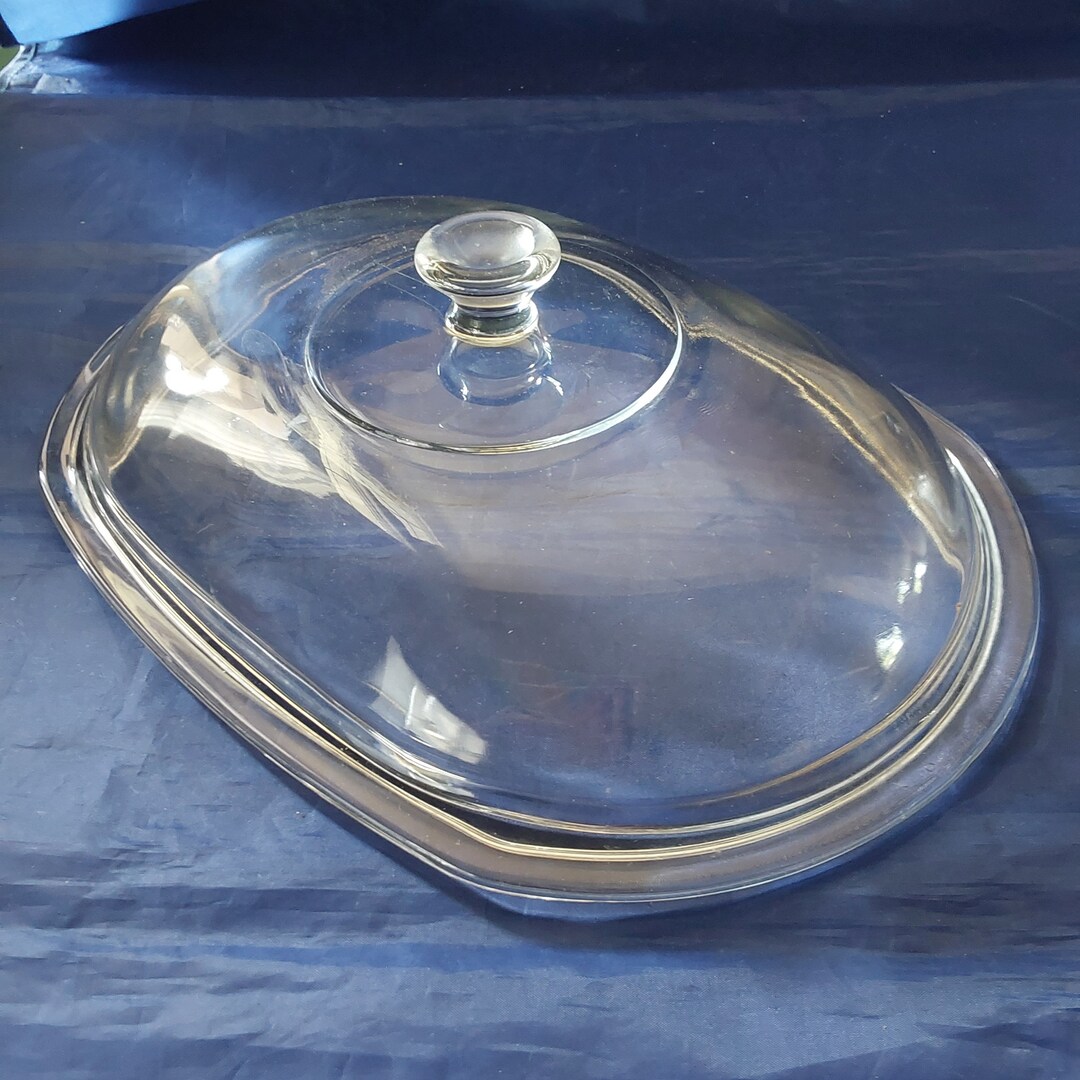 A Large Clear Glass Oval Casserole Dish Lid Only With a Center Knob ...