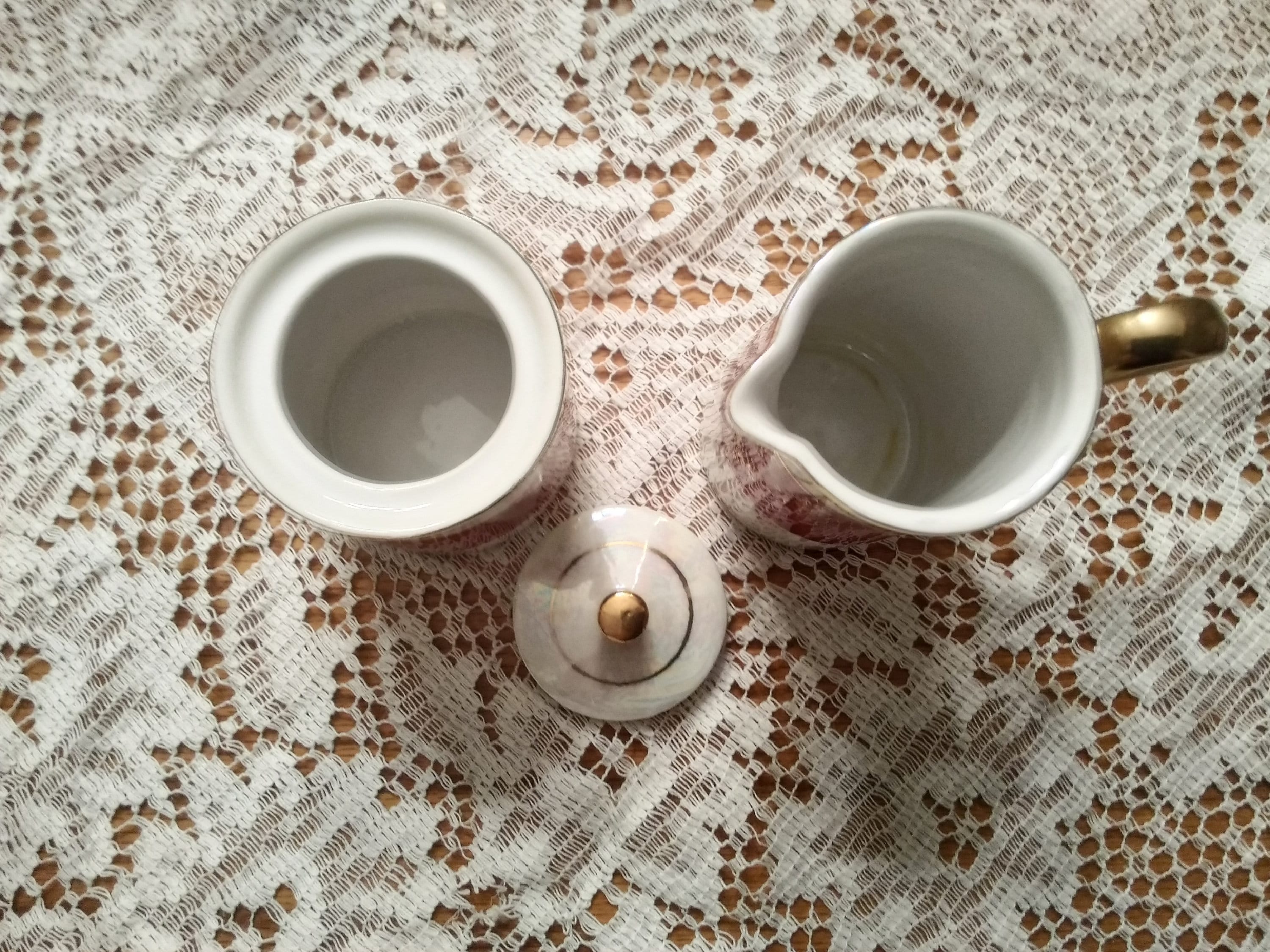 A 15 Piece Porcelain Tea Set in White, Maroon, and Gold Lusterware. the ...