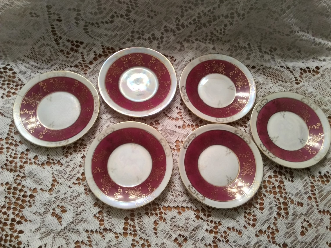 A 15 Piece Porcelain Tea Set in White, Maroon, and Gold Lusterware. the ...