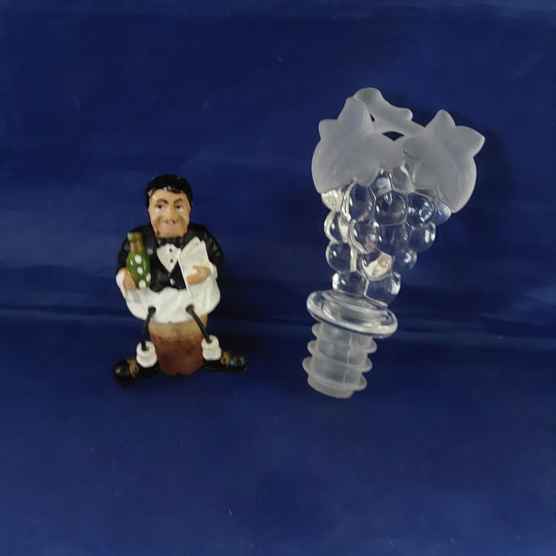 Two Wine Bottle Stoppers. One is a Clear Cluster of Grapes. the Second ...
