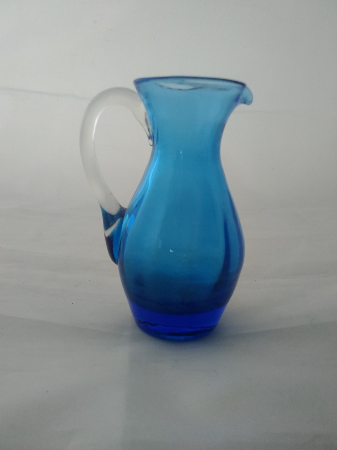 A Clear Blue Hand Blown Glass Miniature Pitcher With an Applied Clear ...