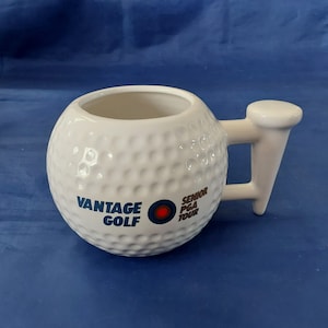 A White Ceramic Golf Ball Shaped 15 Oz Mug With a Golf Tee for a Handle ...