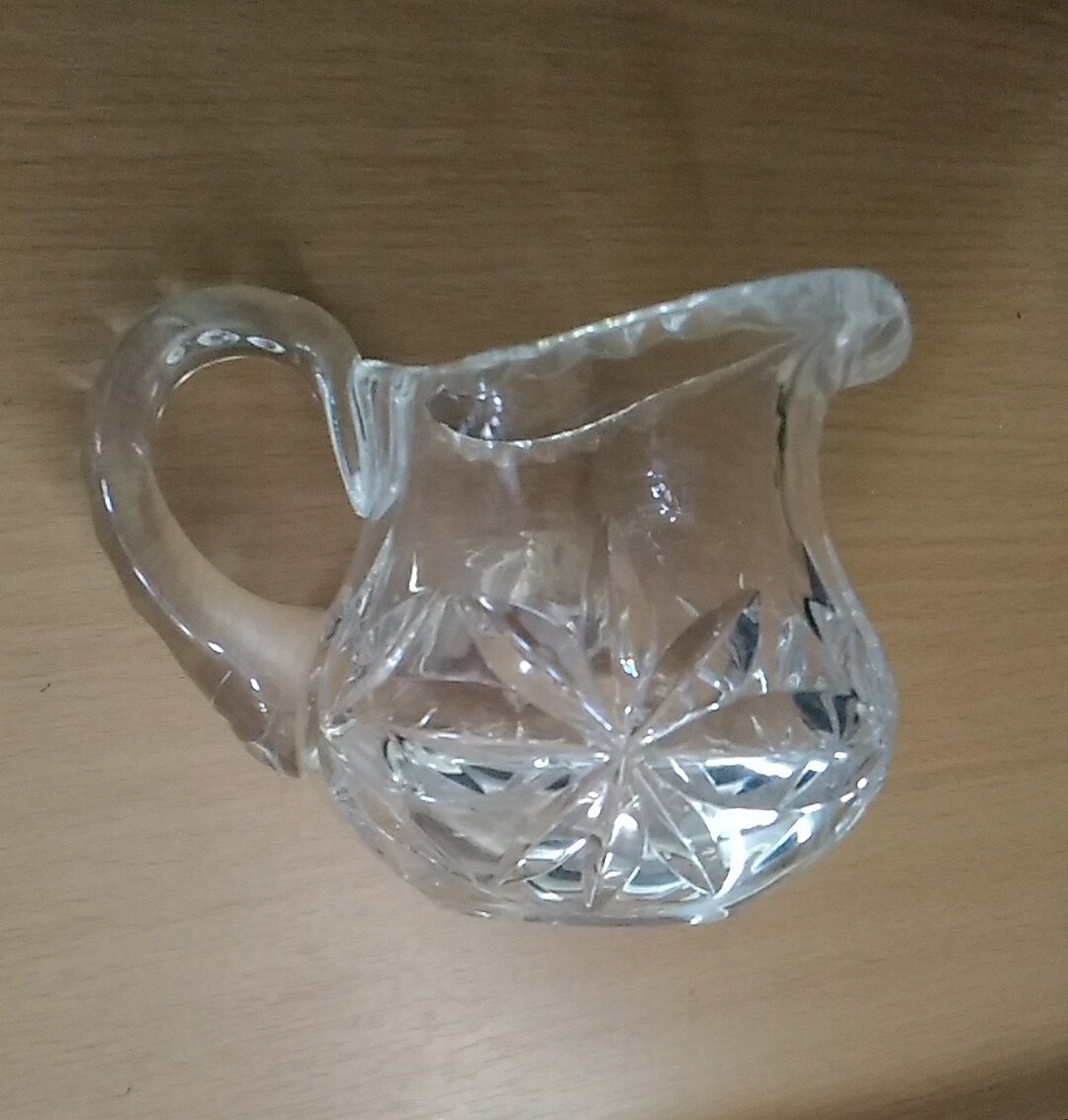 A Small Clear Leaded Crystal Creamer, Decorated With a Starburst ...