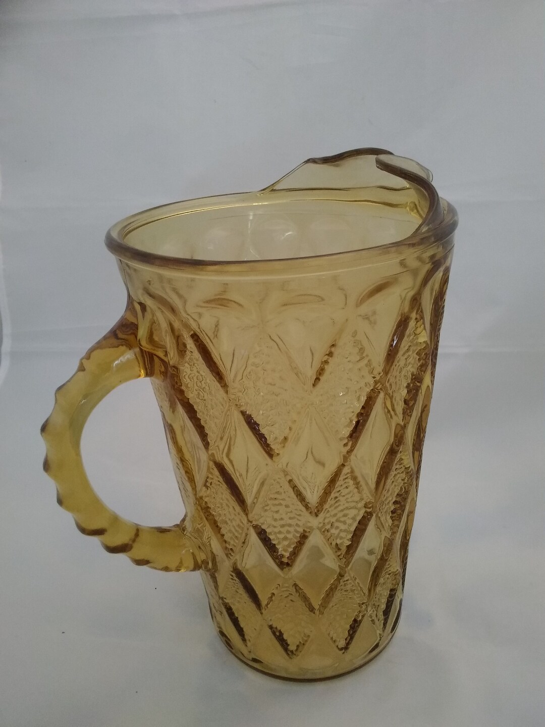An Amber Mid Century Modern Glass 10 Inch Tall Water Pitcher With a ...