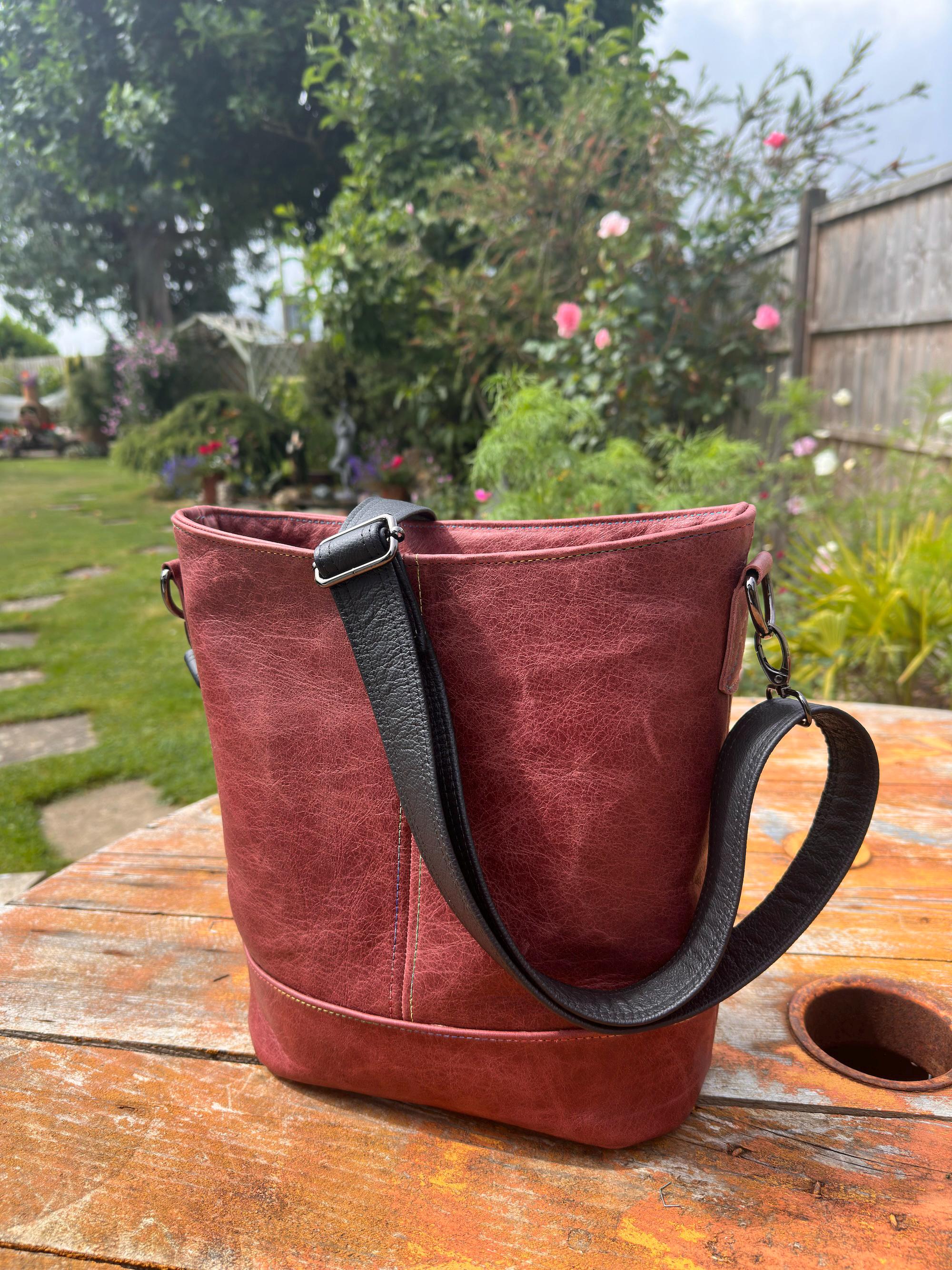 Black leather bucket bag red interior store