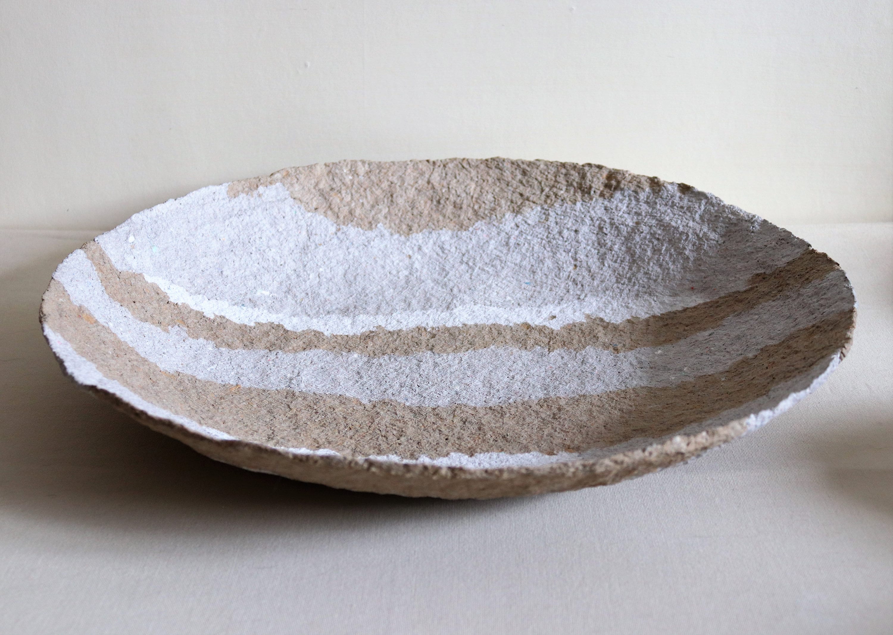 A Large Paper Mache Plate With Stripes of Different Gray and Brown ...