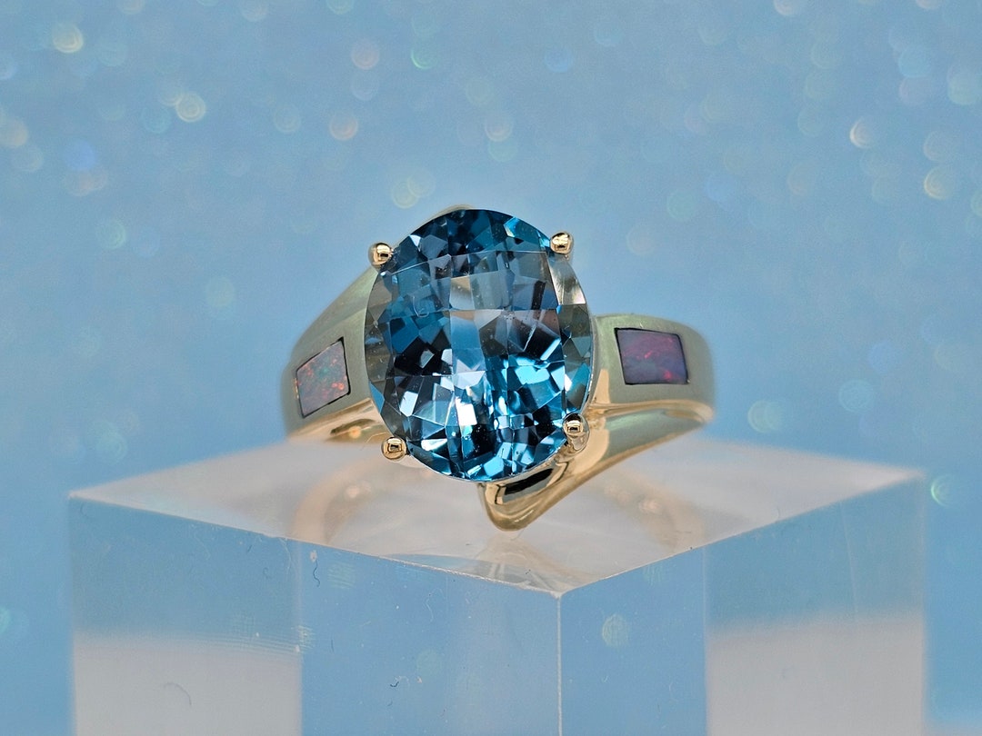 Circa 1990, a 10k Yellow Gold Checker-board Cut Oval Blue Topaz With ...