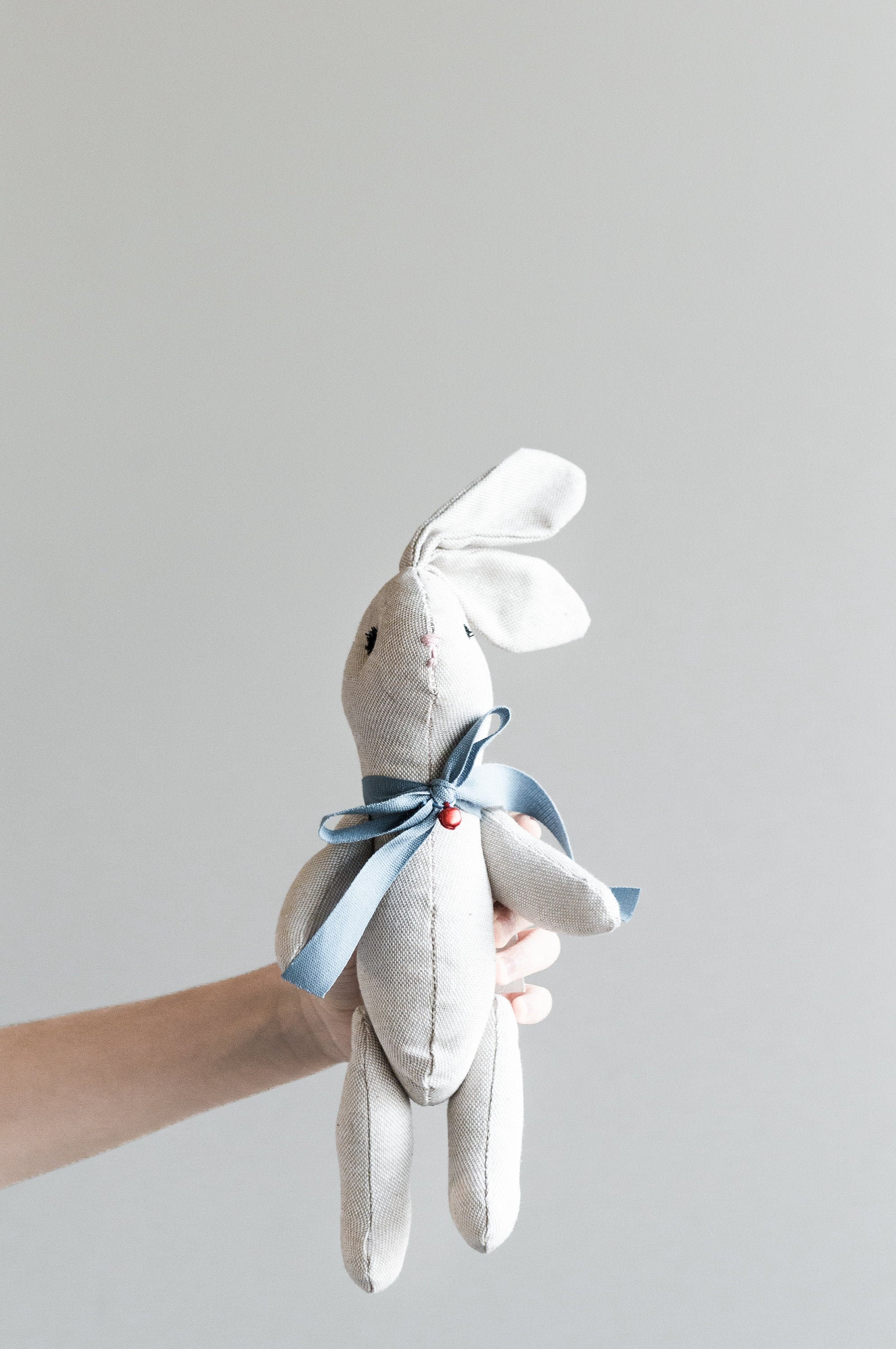 plush bunny-shaped with blue bow and red bell. Custom.