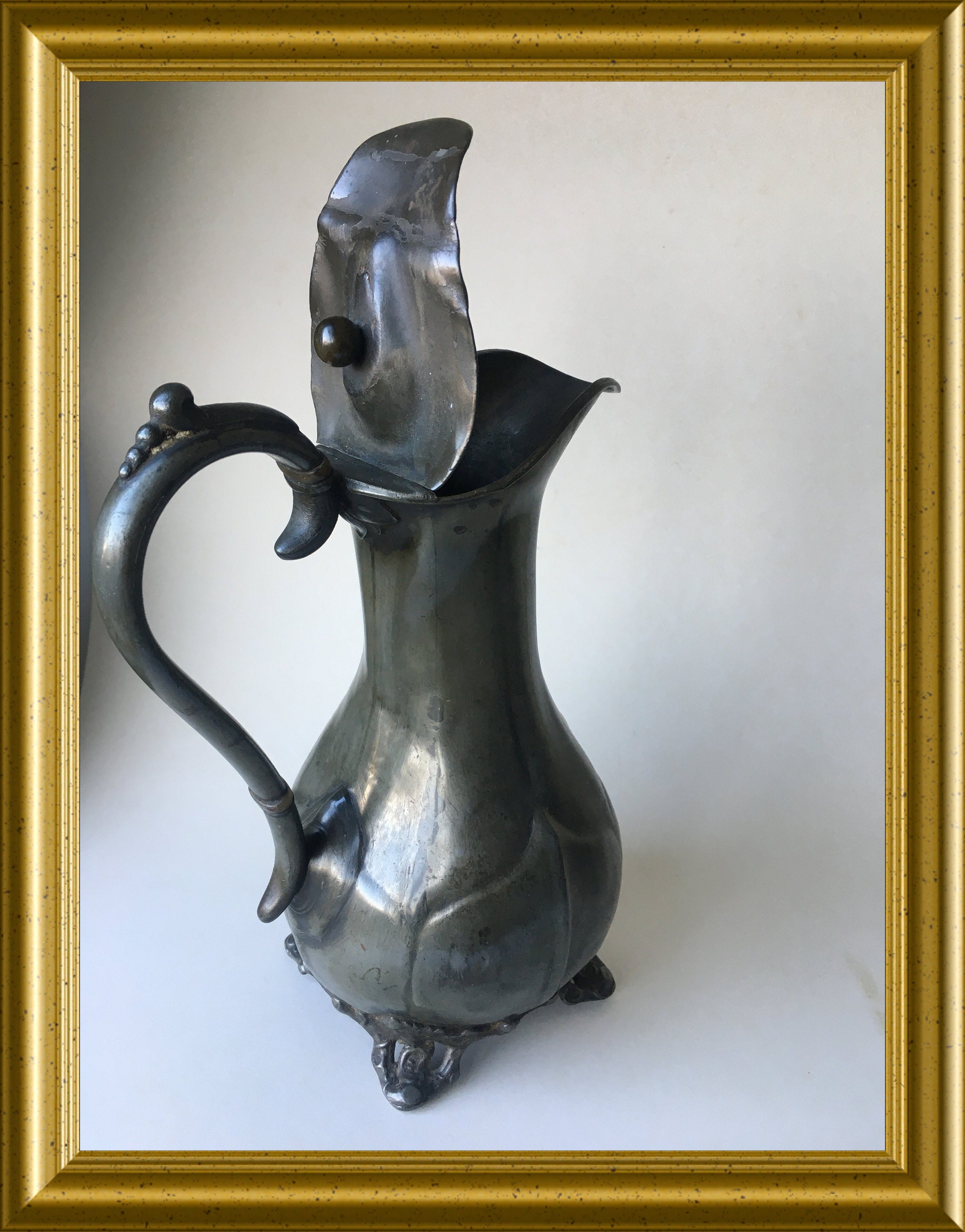 Antique lidded pewter jug