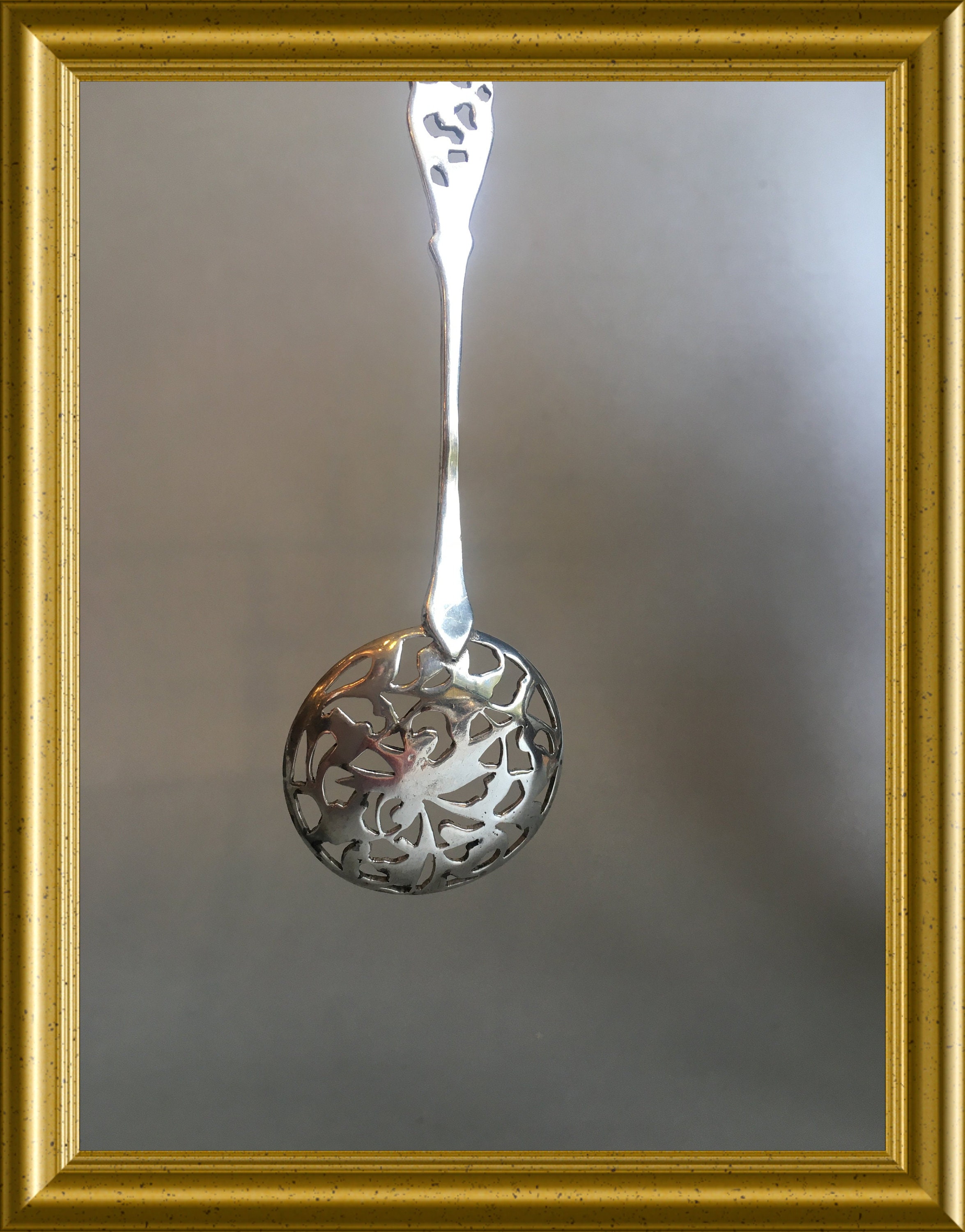 Antique small ornate pierced silver serving spoon: bird