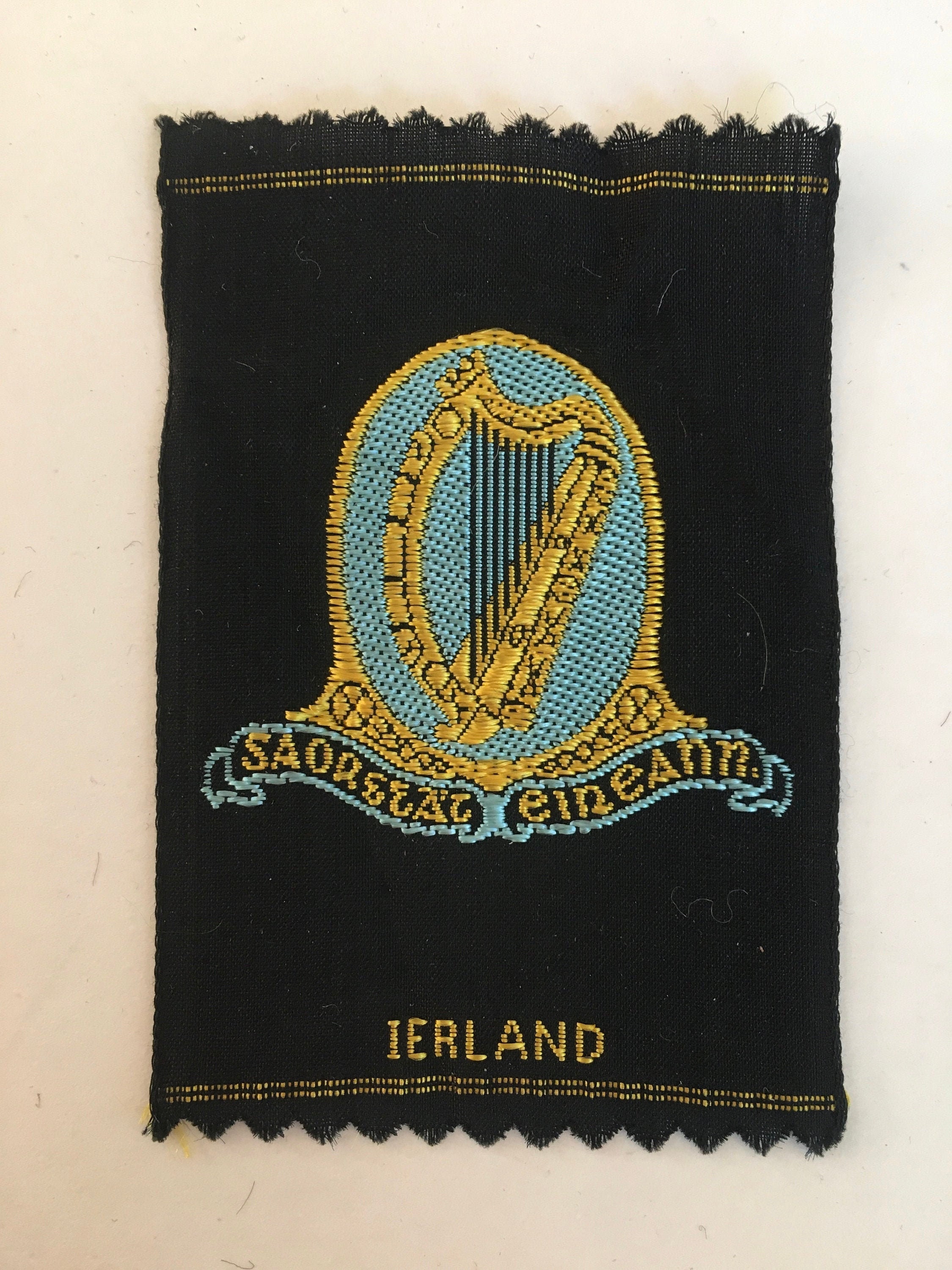 Antique Turmac woven silk tobacco patch: arms Ireland, harp