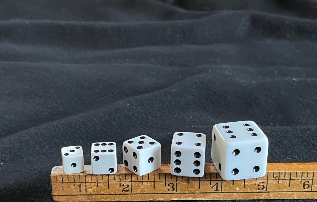 Five White Dice in Different Sizes From Diminutive to Overlarge ...