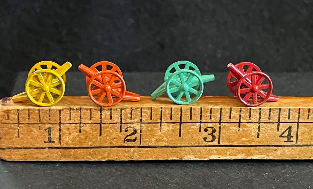 Four Vintage 1960 Metal Wheeled Cannon Playing Tokens -- Orange, Red ...