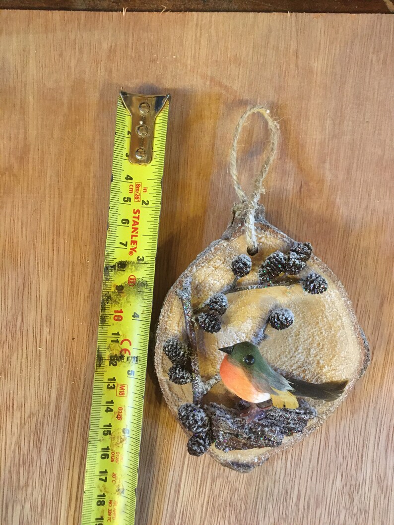 A hanging decoration with a robin on with fake spring flowers | Etsy