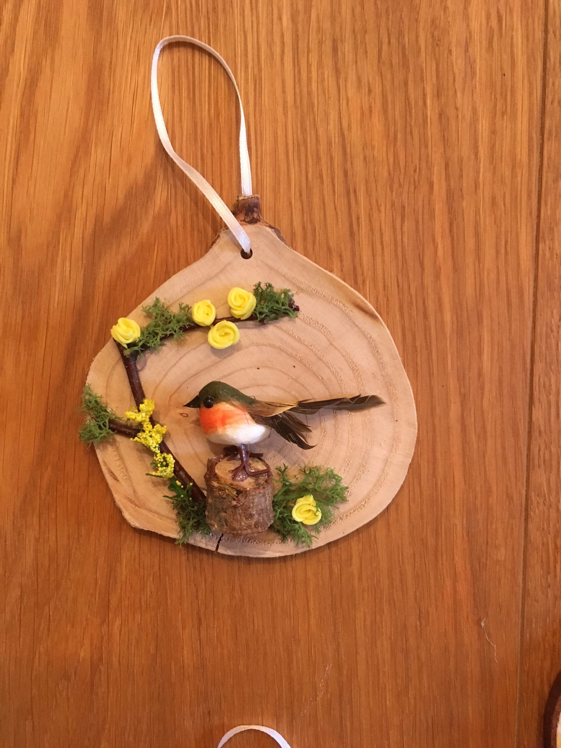 A hanging decoration with a robin on with fake spring flowers | Etsy