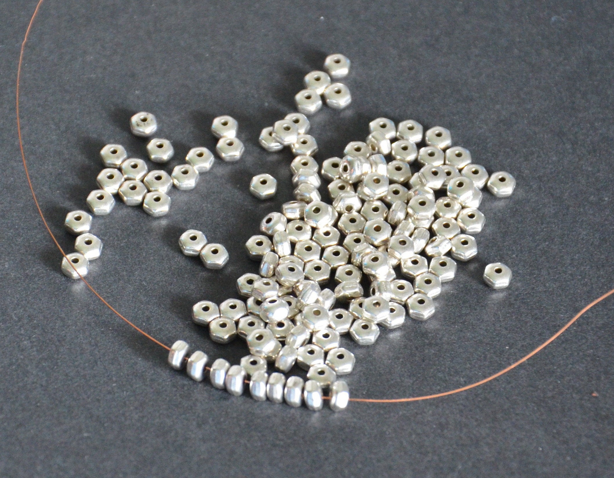 A set of 30g 4.52.8mm hexagon beads-1.0mm hole alloy | Etsy