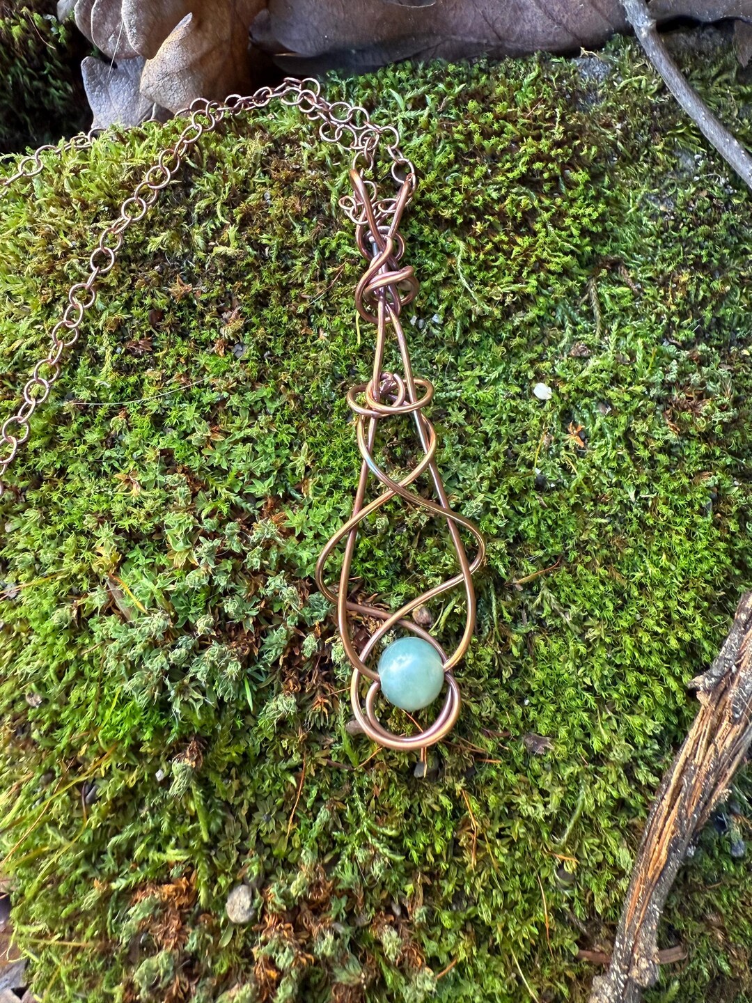 Copper Wire Wrap Around an Indian Agate Bead Hung From a Copper Plate ...
