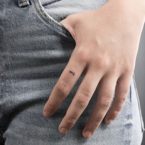 Cursive Lowercase M Tattoo