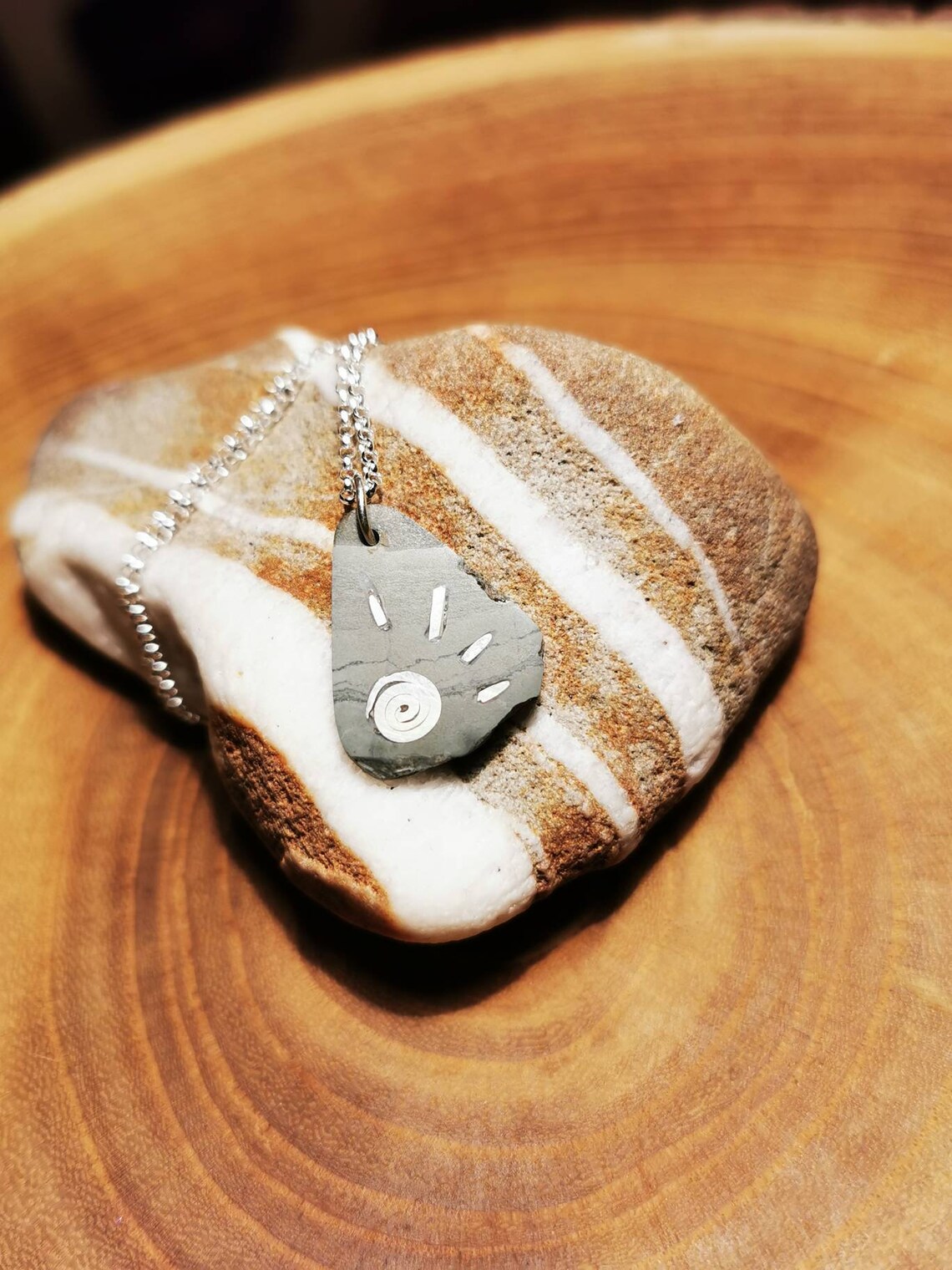 Gray Welsh slate pendant with a silver sunburst | Etsy