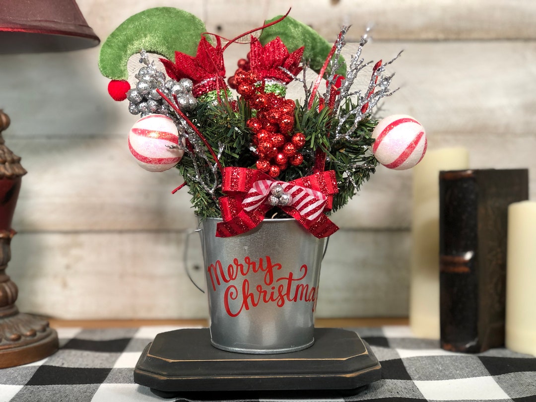 Elf Dives Into Christmas. Metal Bucket With Christmas Floral and Red ...