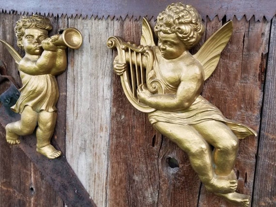 Statues These two golden Dart Industries cherubs are sure to add a ...