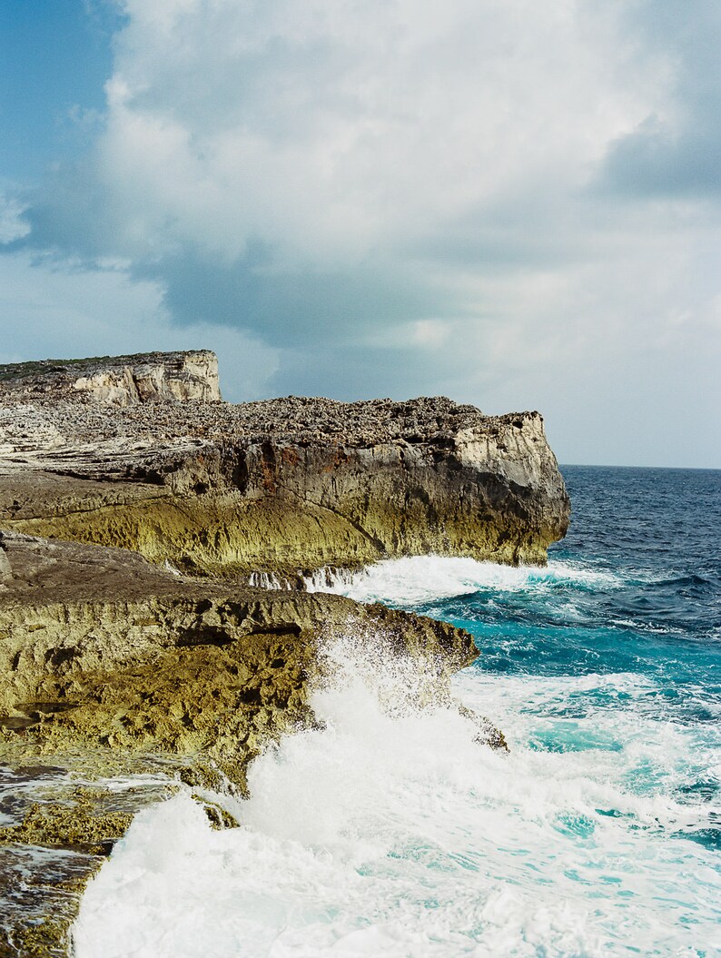 Vertical Photo of Rocky Cliffs Looking Out Over Crashing Ocean Waves in ...