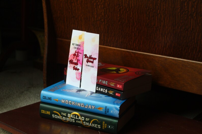 Hunger Games Book Merch Featuring dates With Hunger Games & Prequel ...