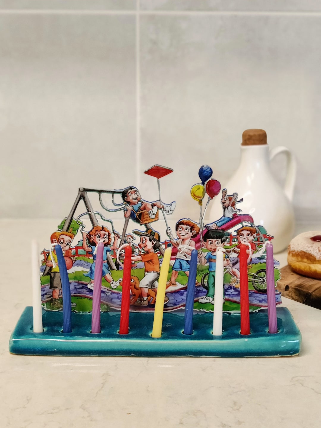 Multicolored Metal Hanukkah Menorah With Children Play in a Playground ...