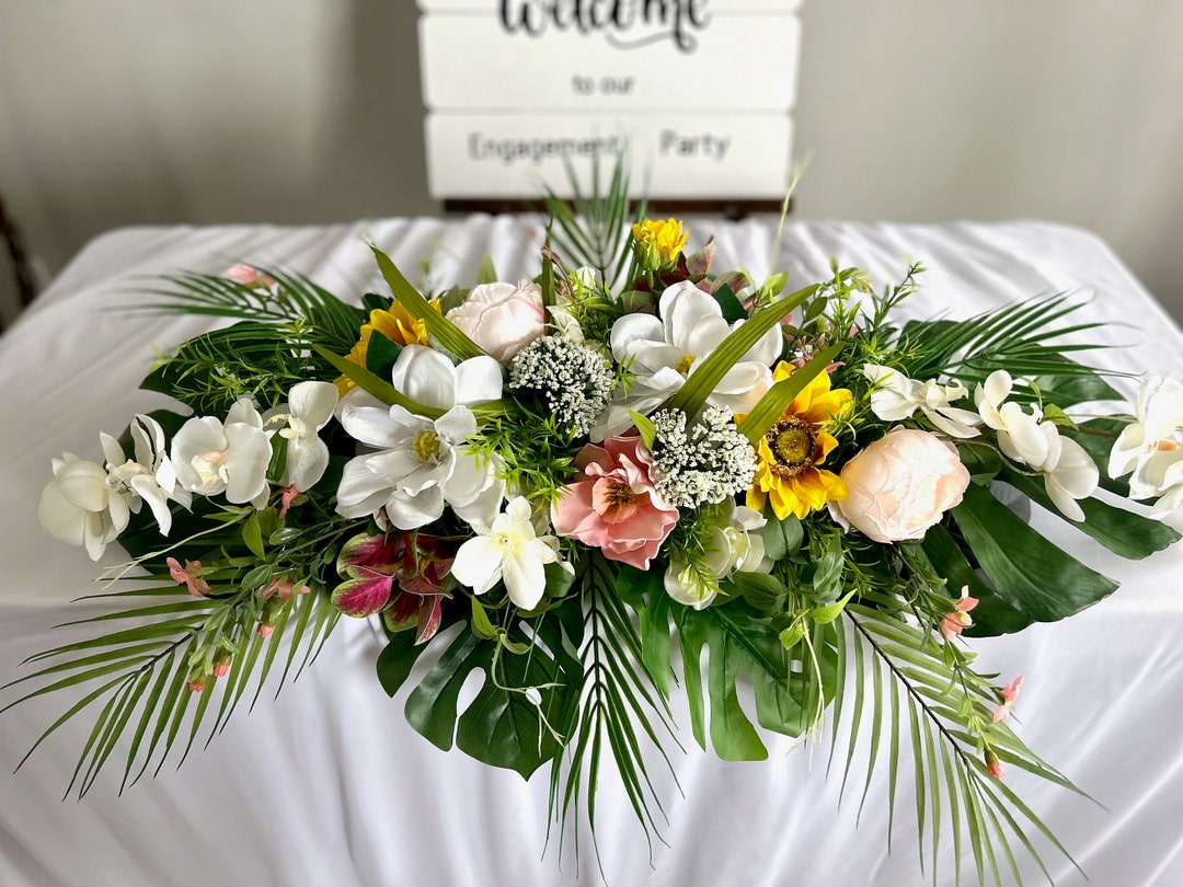 Sweetheart Table Arrangement Made With Tropical Foliages and Sunflowers ...