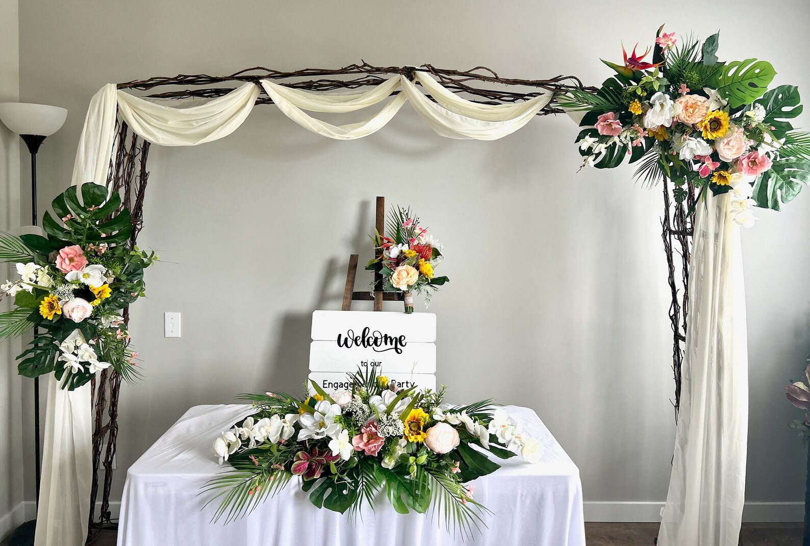 Sweetheart Table Arrangement Made With Tropical Foliages and Sunflowers ...