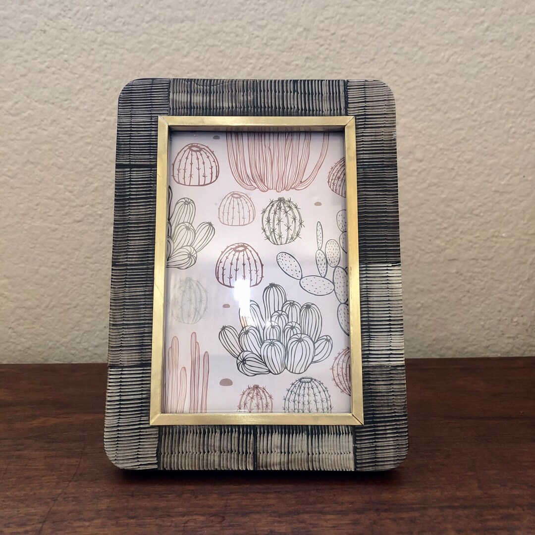 Vintage Style Navy Textured Wood Frame With Brass Edge Detail Holds a ...