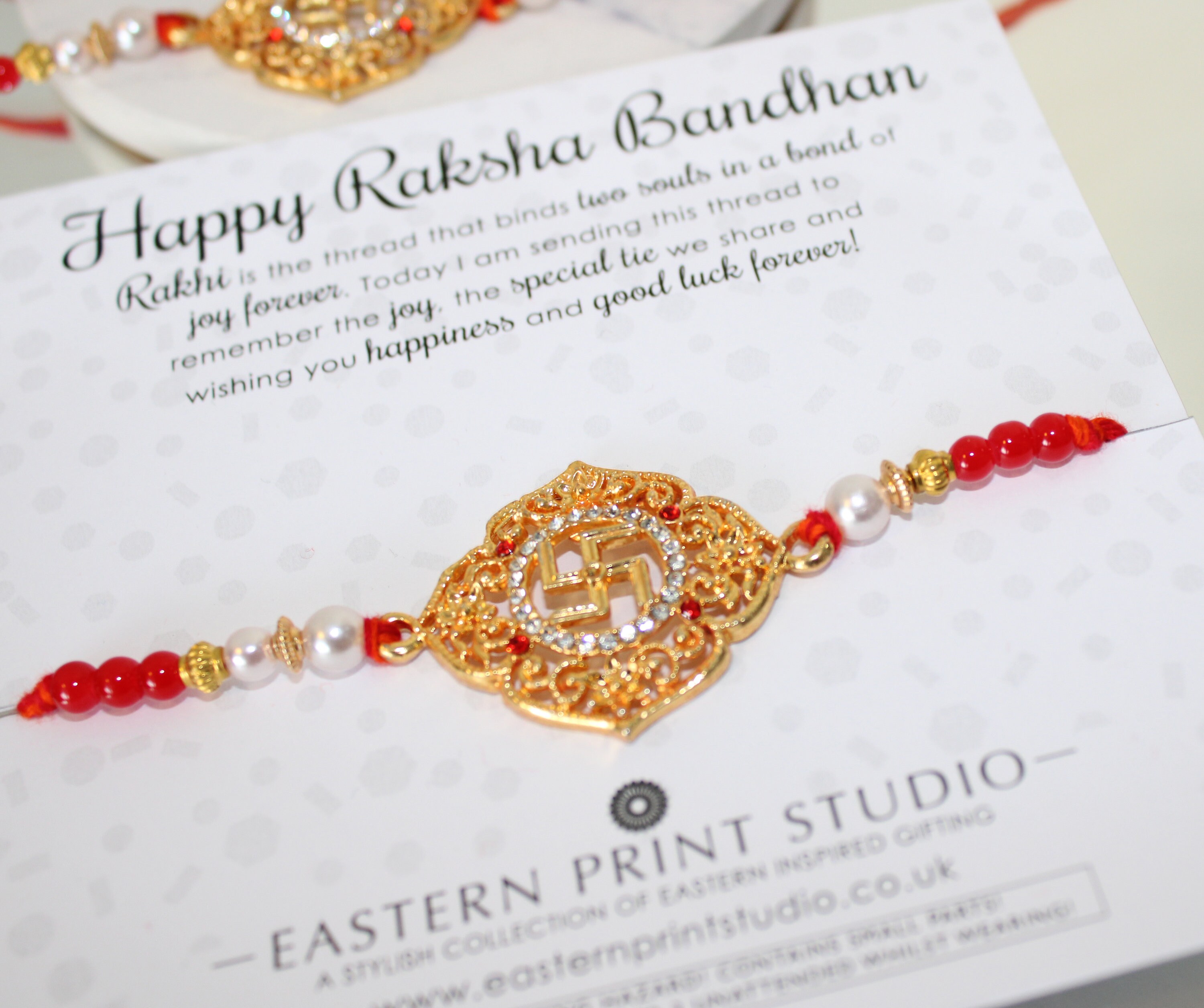 Luxury Gold Swastika Rakhi Presented on a luxury backing | Etsy