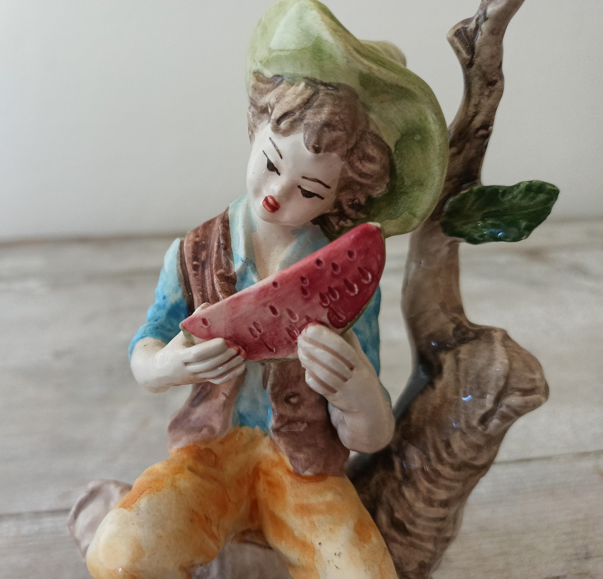 Porcelain Figurine Depicting a Boy Eating Watermelon: a Vintage Display ...