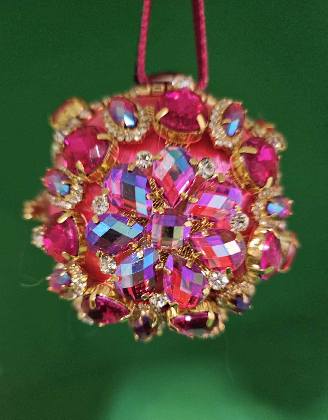 Giant Iridescent Pink Jewel Medallions Decorate This Pink Satin ...