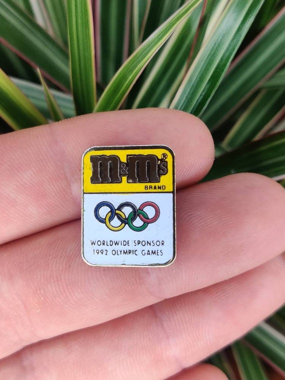 M and M's 1992 Olympic games sponsor pin badge Hat ti… - Gem