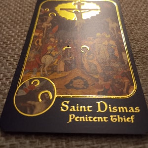 St. Dismas Holy Card With Gold Foil Border. It is 2.75