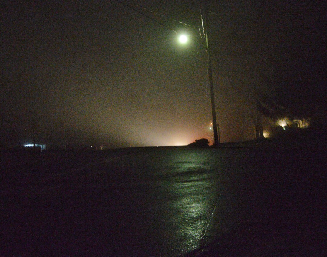 Eerie Foggy Night With Lone Street Lamp and Reflections With Multiple ...