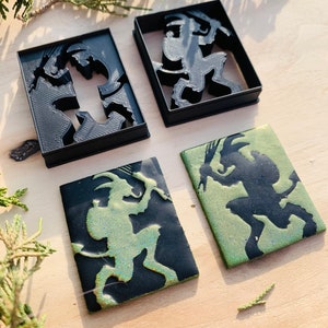 Inverted Mirrored Pair of Krampus Silhouettes Embossed Sharp Clay ...