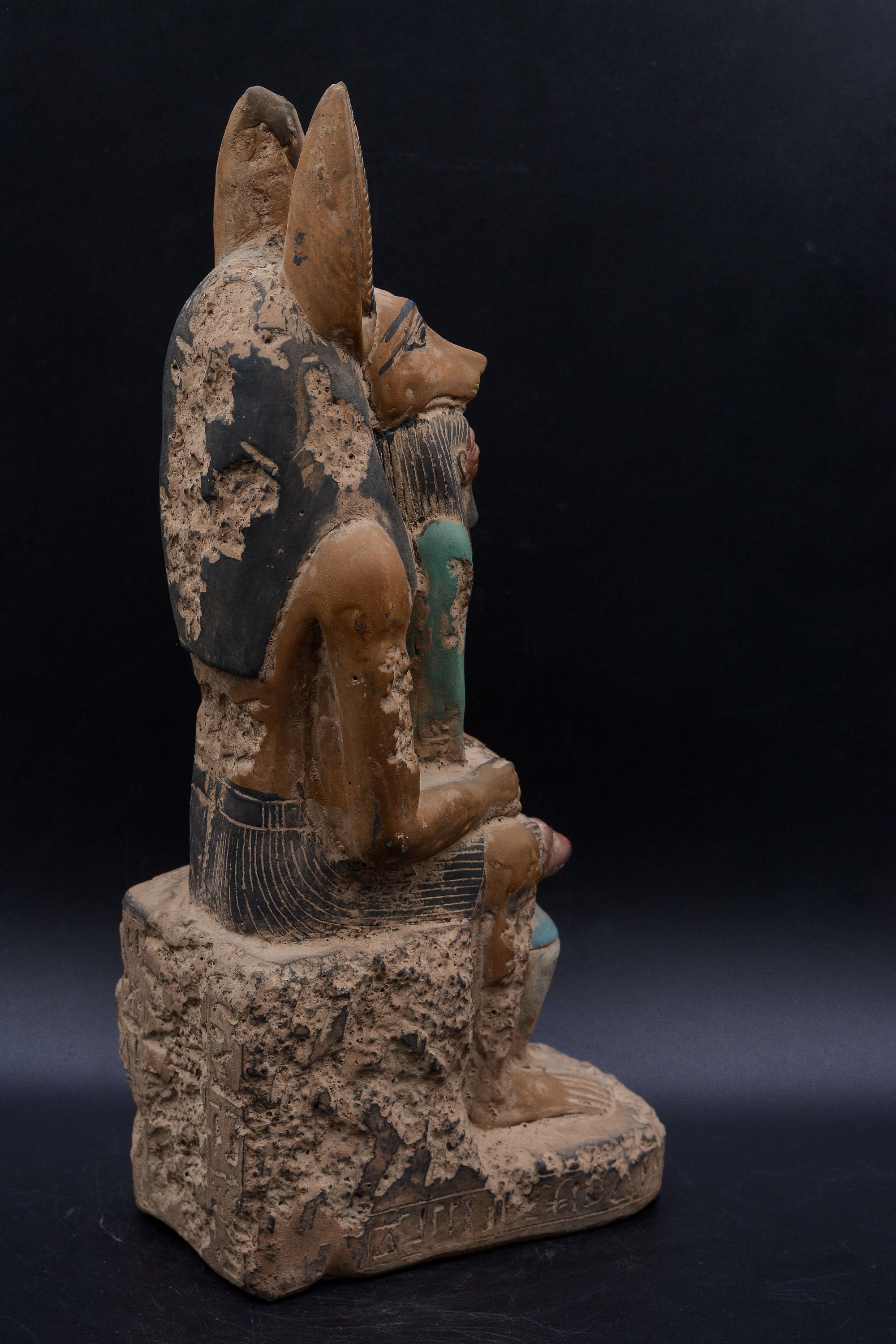 Seated Anubis Holding a Mummy Form With a Hapi (son of Horus) Resting ...