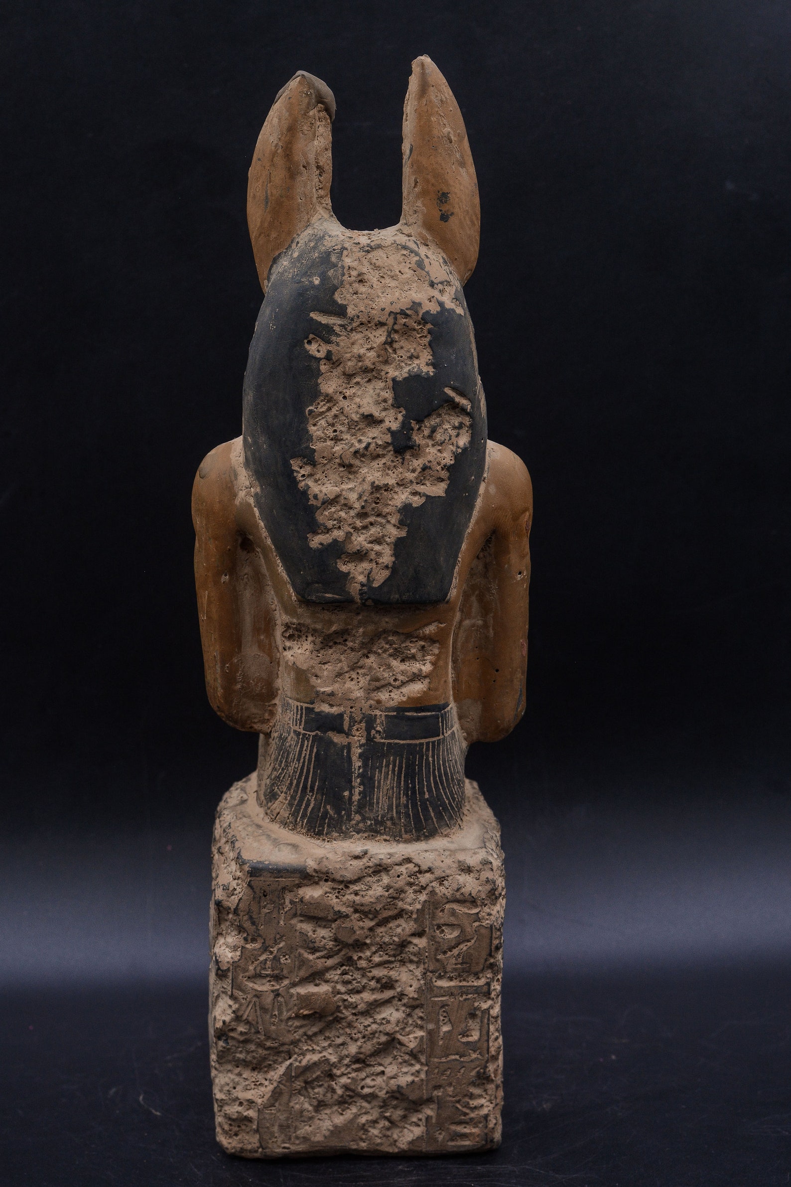 Seated Anubis Holding a Mummy Form With a Hapi (son of Horus) Resting ...