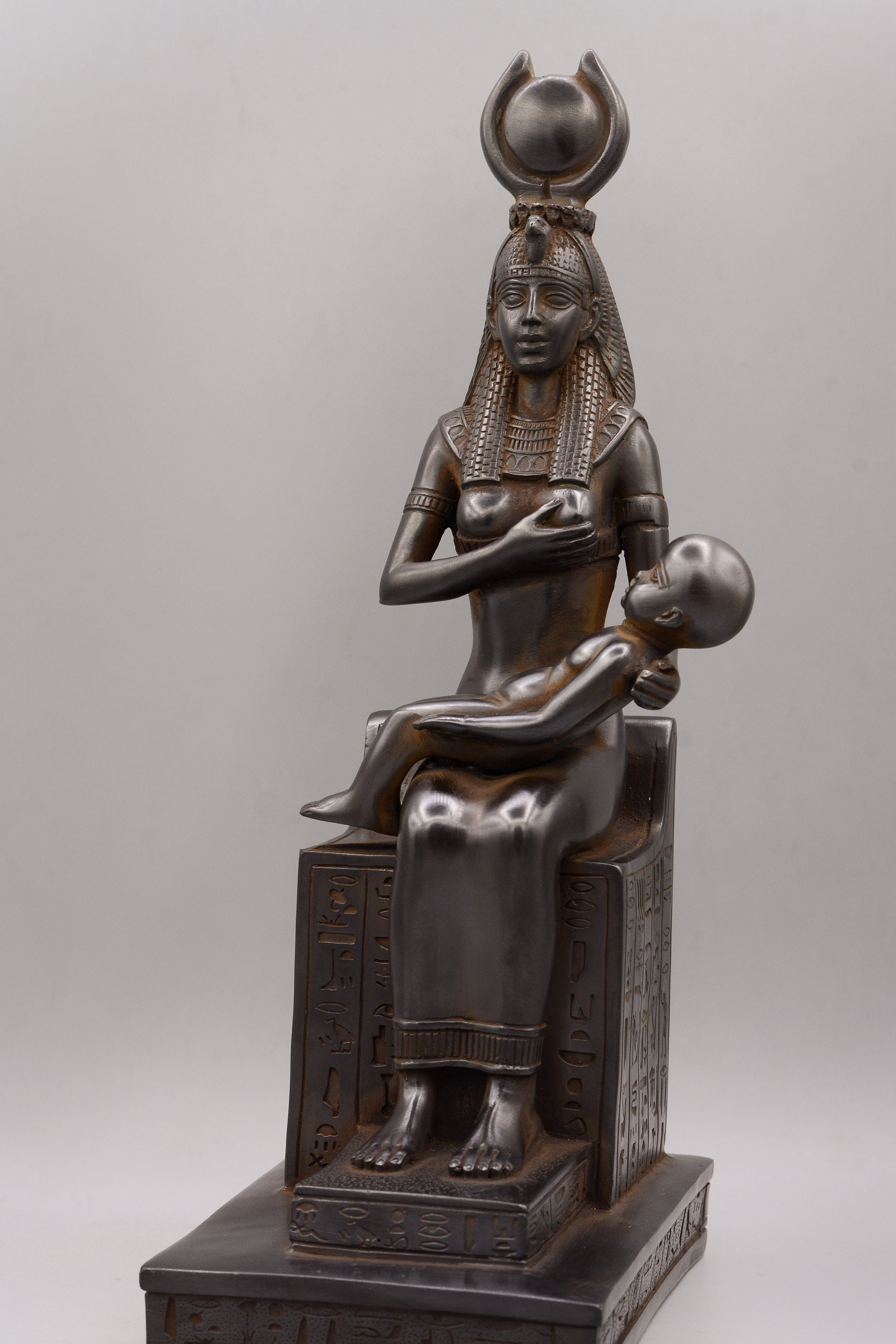 Ancient Egyptian statue of goddess Isis breastfeeds her son Horus made ...