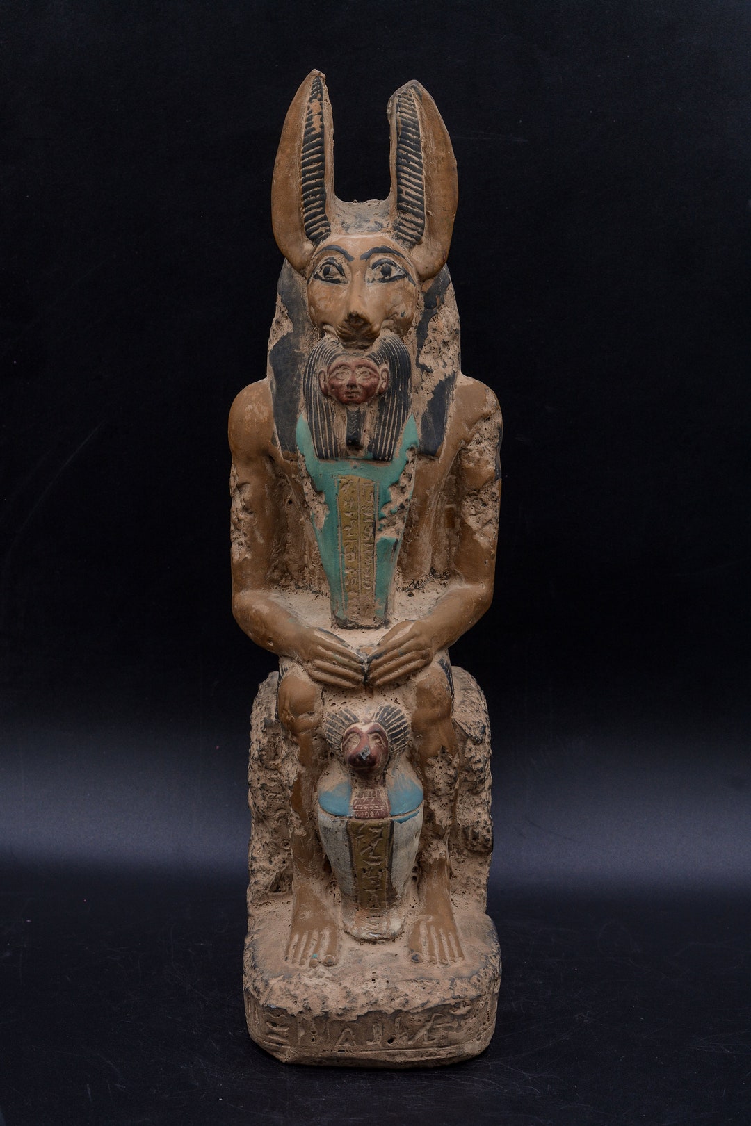 Seated Anubis Holding a Mummy Form With a Hapi (son of Horus) Resting ...