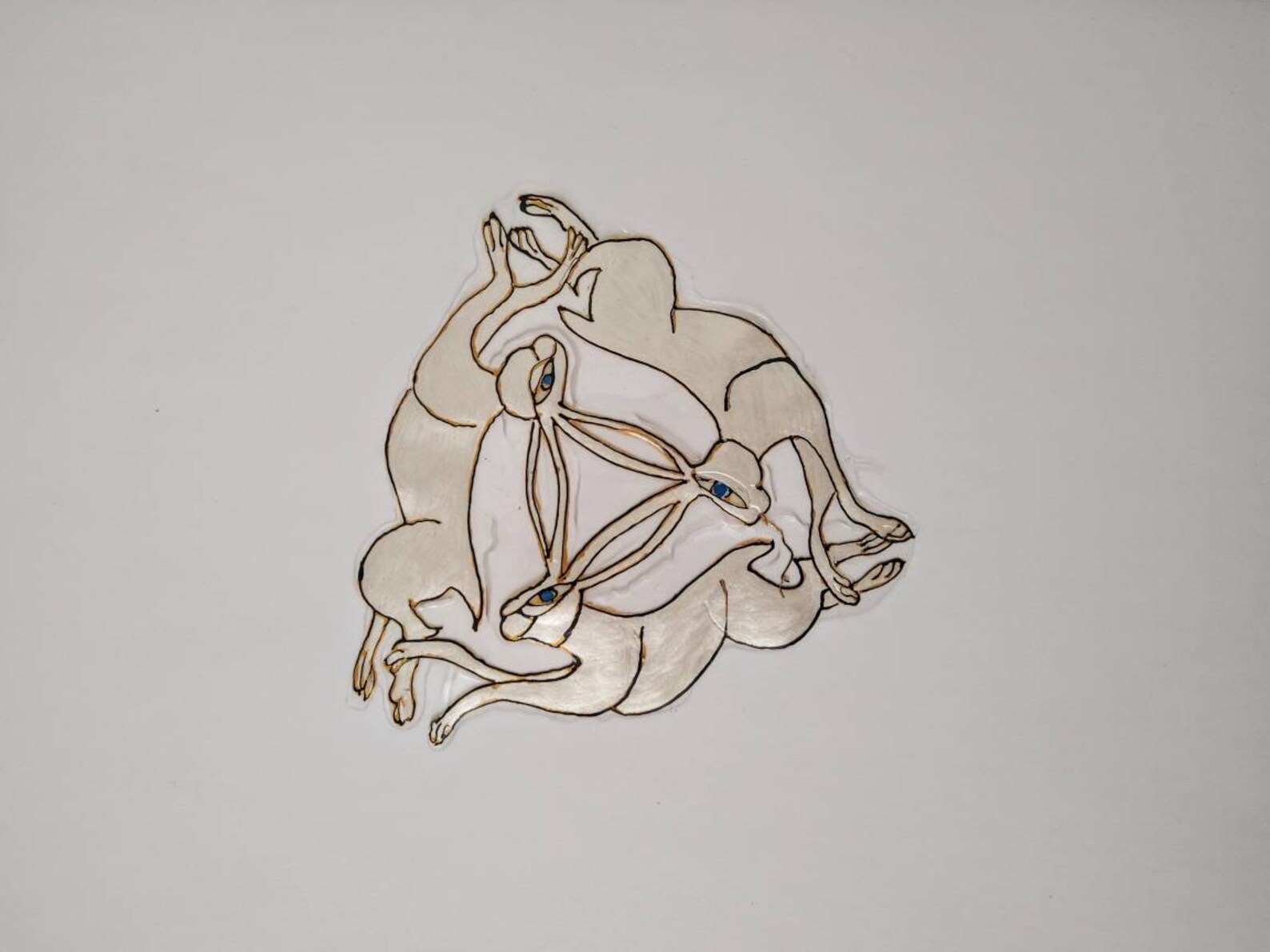 Three running rabbits symbol. White with gold accents . Hand | Etsy