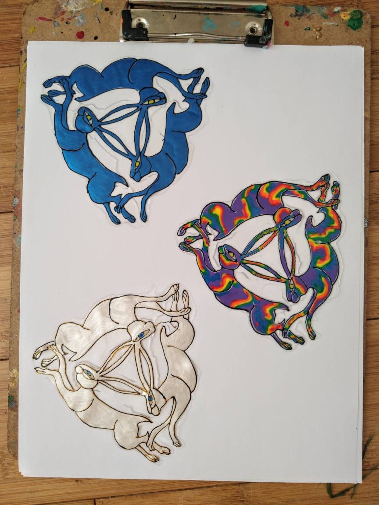 Three running rabbits symbol. White with gold accents . Hand | Etsy