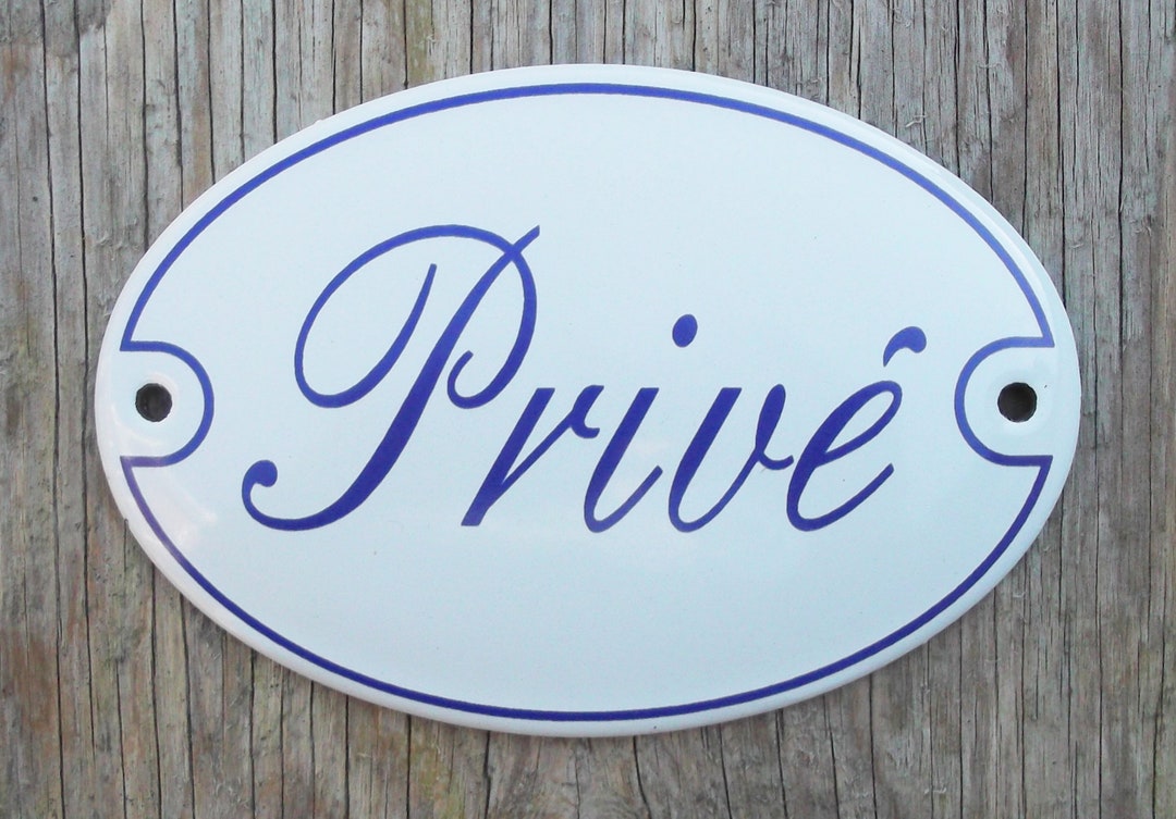 Classic Enamels Prive Sign. Blue Text on a White Background, Blue ...