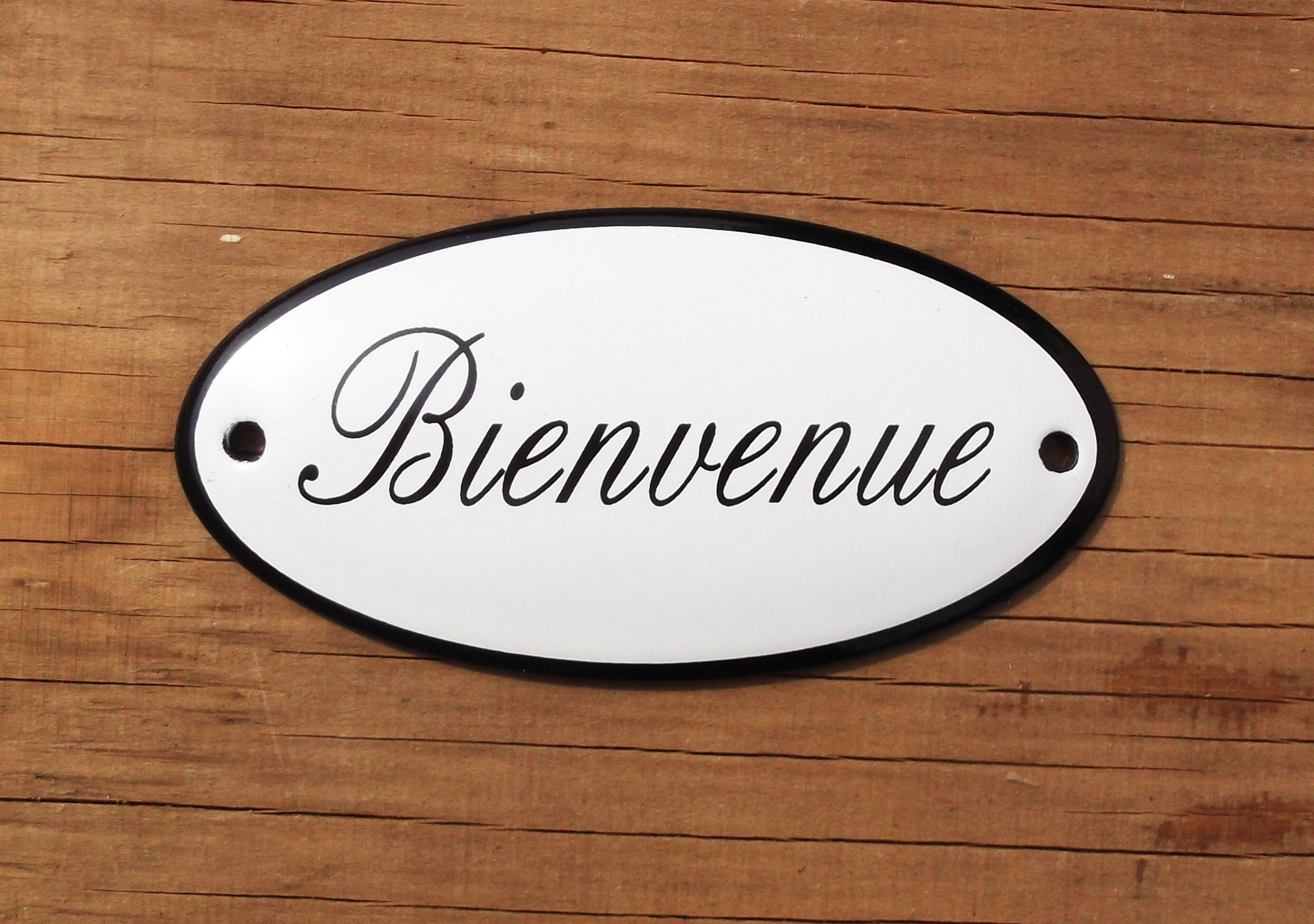 Classic Enamels Bienvenue Sign. Black Text on a White Background ...