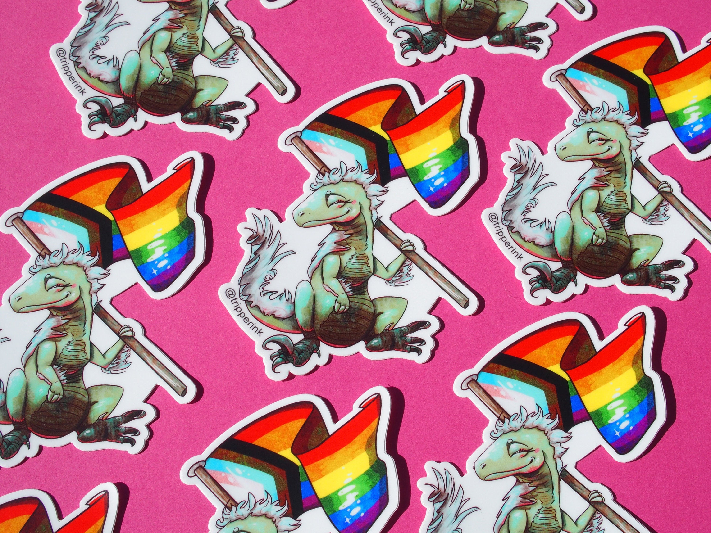 Dinosaur holding a gay pride flag sticker — Crooked Stickers