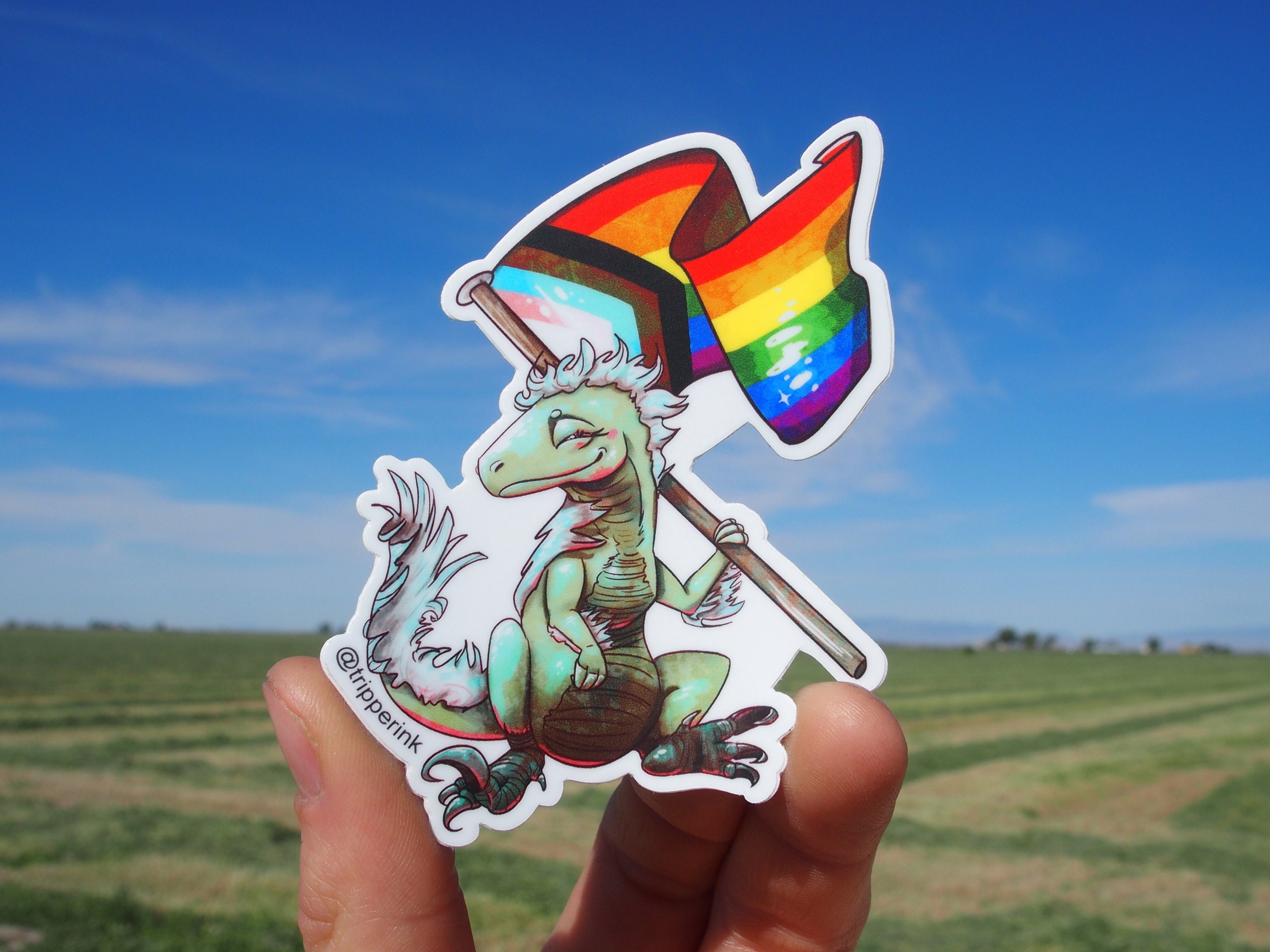 Dinosaur holding a gay pride flag sticker | Crooked Stickers