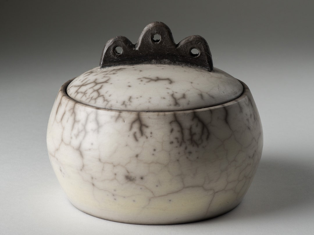 Light yellow hand thrown naked raku pot with lid. Signed IF on the base ...